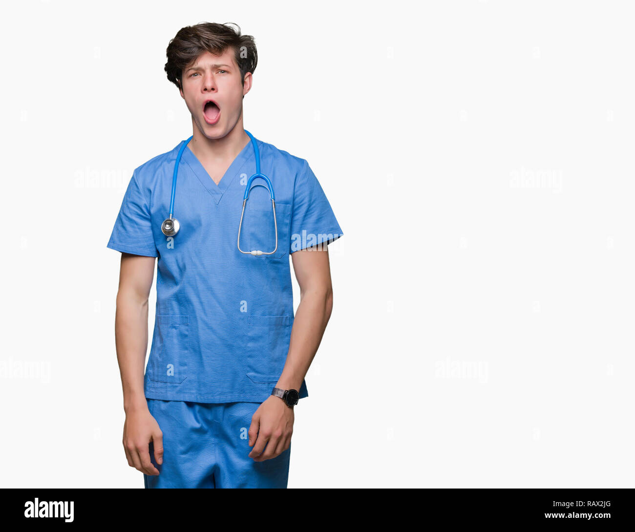 Young doctor wearing medical uniform over isolated background In shock ...