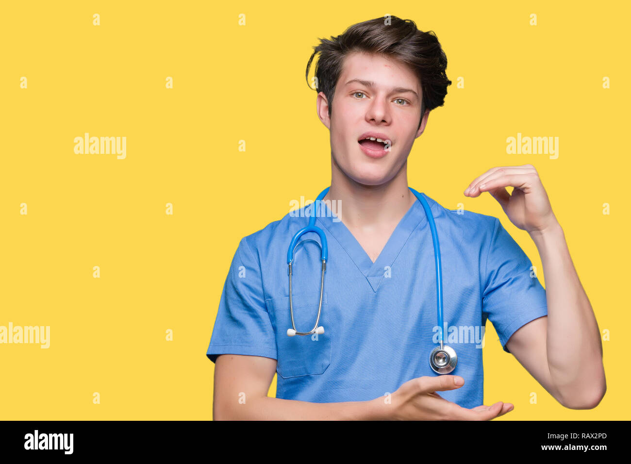 Young doctor wearing medical uniform over isolated background gesturing ...