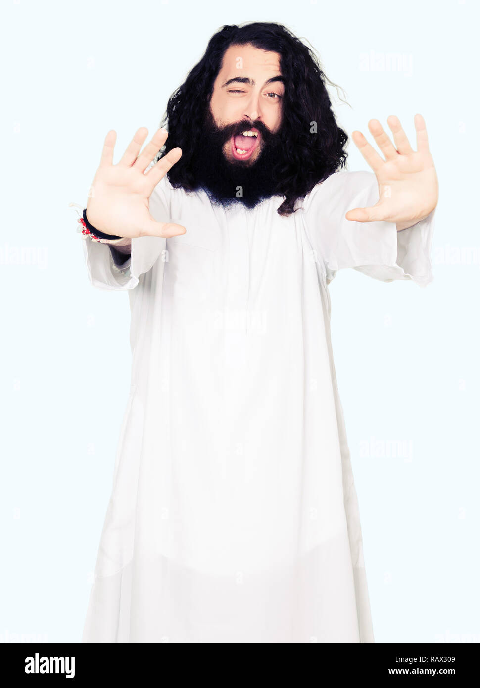 Man wearing Jesus Christ costume afraid and terrified with fear ...