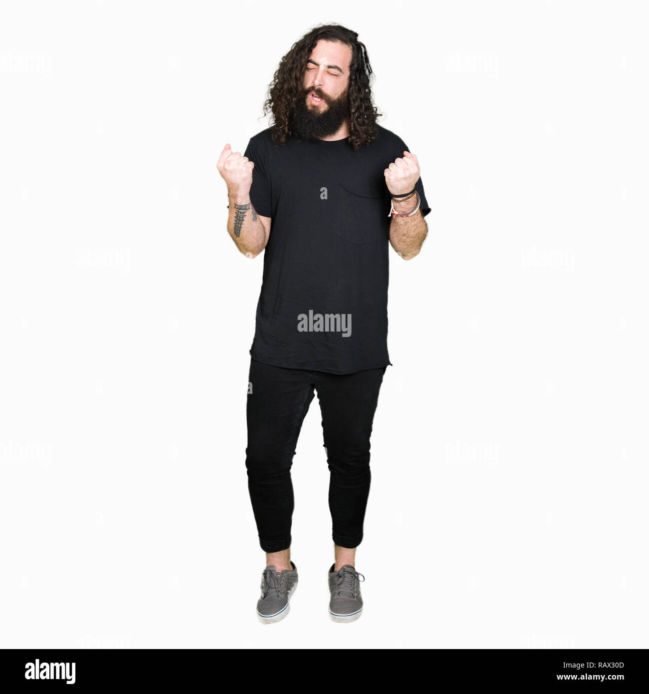 Young man with long hair and beard wearing heavy metal black outfit ...