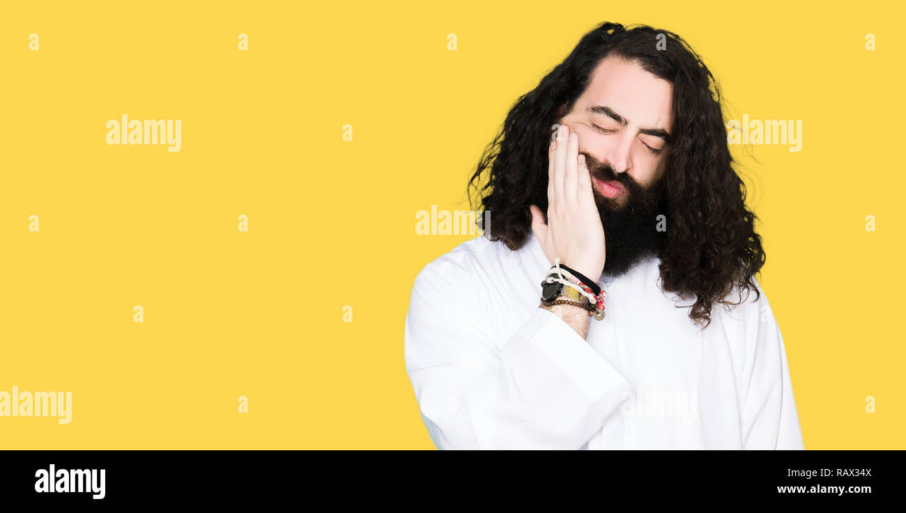 Man wearing Jesus Christ costume touching mouth with hand with painful ...