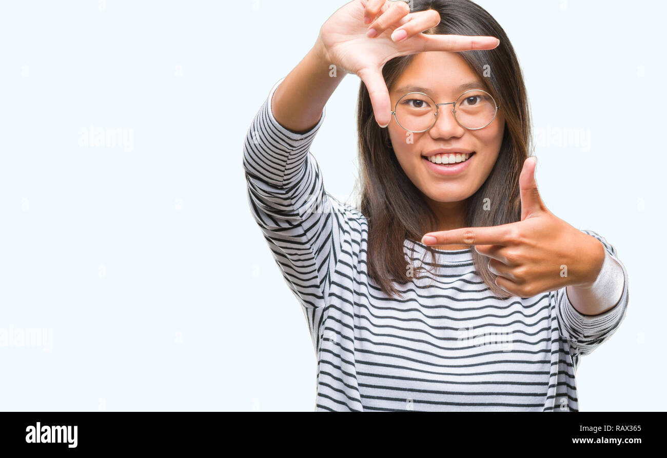 Young asian woman wearing glasses over isolated background smiling ...