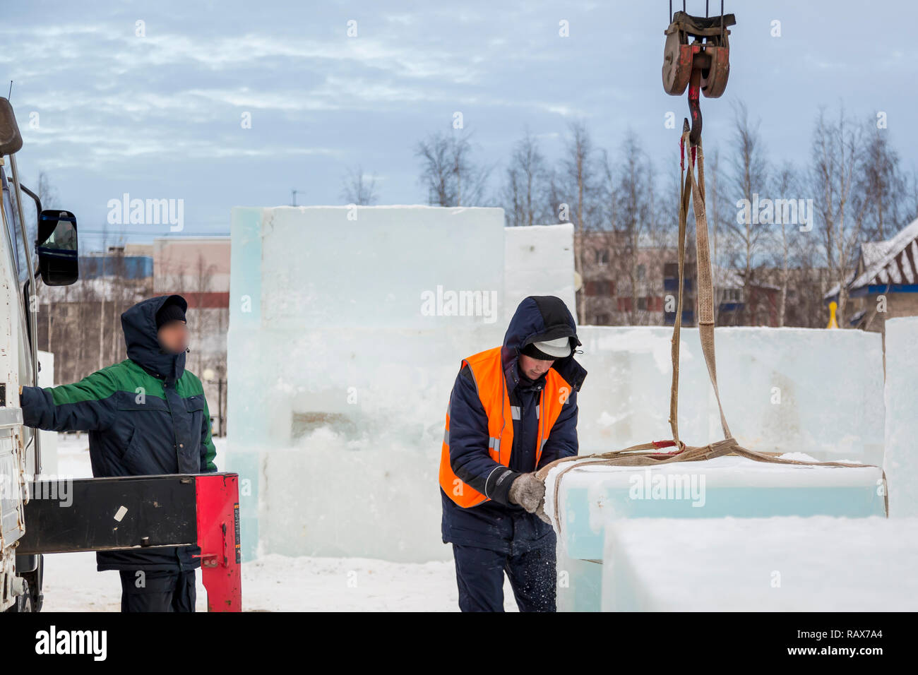 Portrait of an assembler worker in a jacket with a hood and a white ...