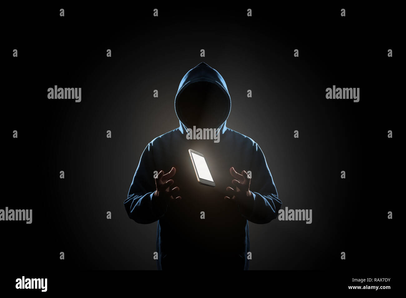 White smartphone floating above of hacker's hand in dark background ...