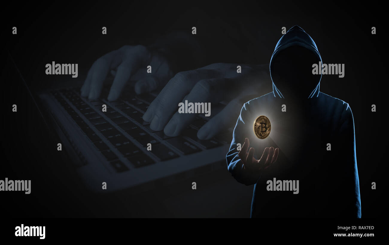 Golden Bitcoin floating above of hacker's hand in dark on hacker ...