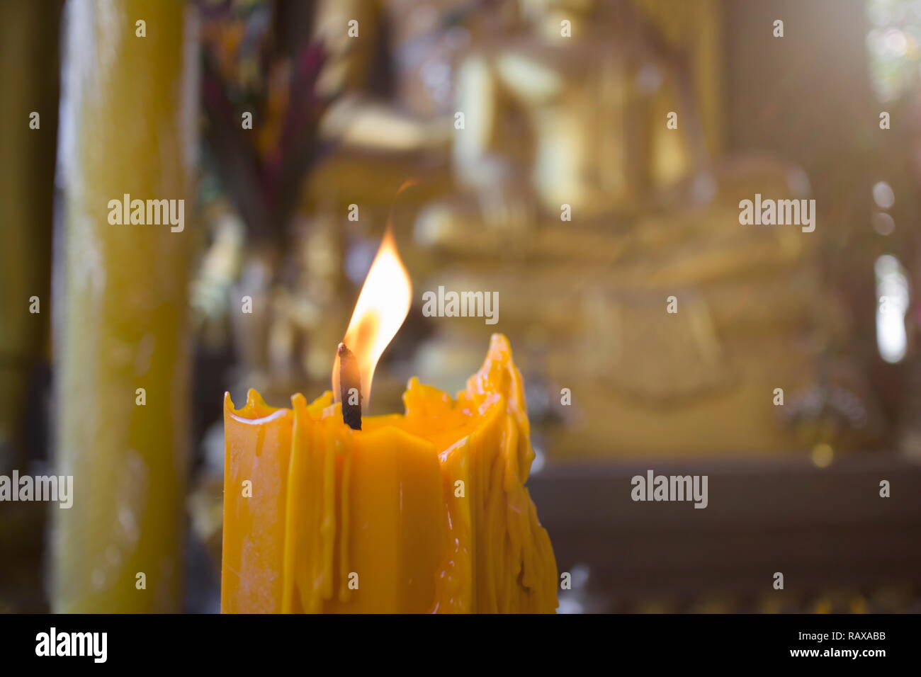 Candlelight with buddha statue in the Thai temple in Lampang province ...