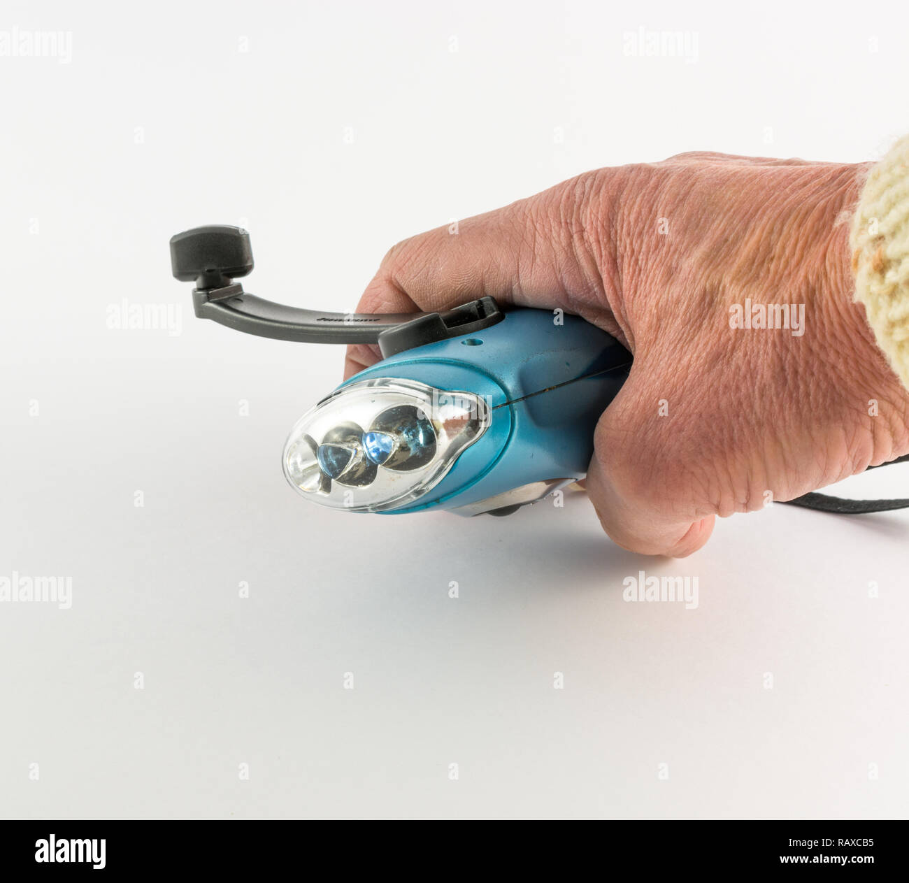 Wind up torch and hands Stock Photo - Alamy