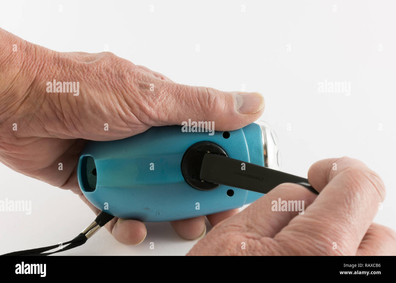 Wind up torch and hands Stock Photo - Alamy