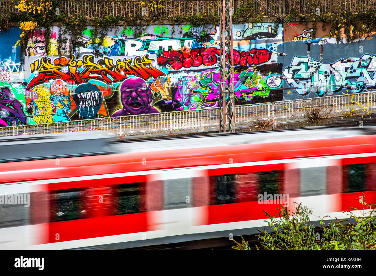 graffiti paintings, on a concrete wall at a railroad track near the ...