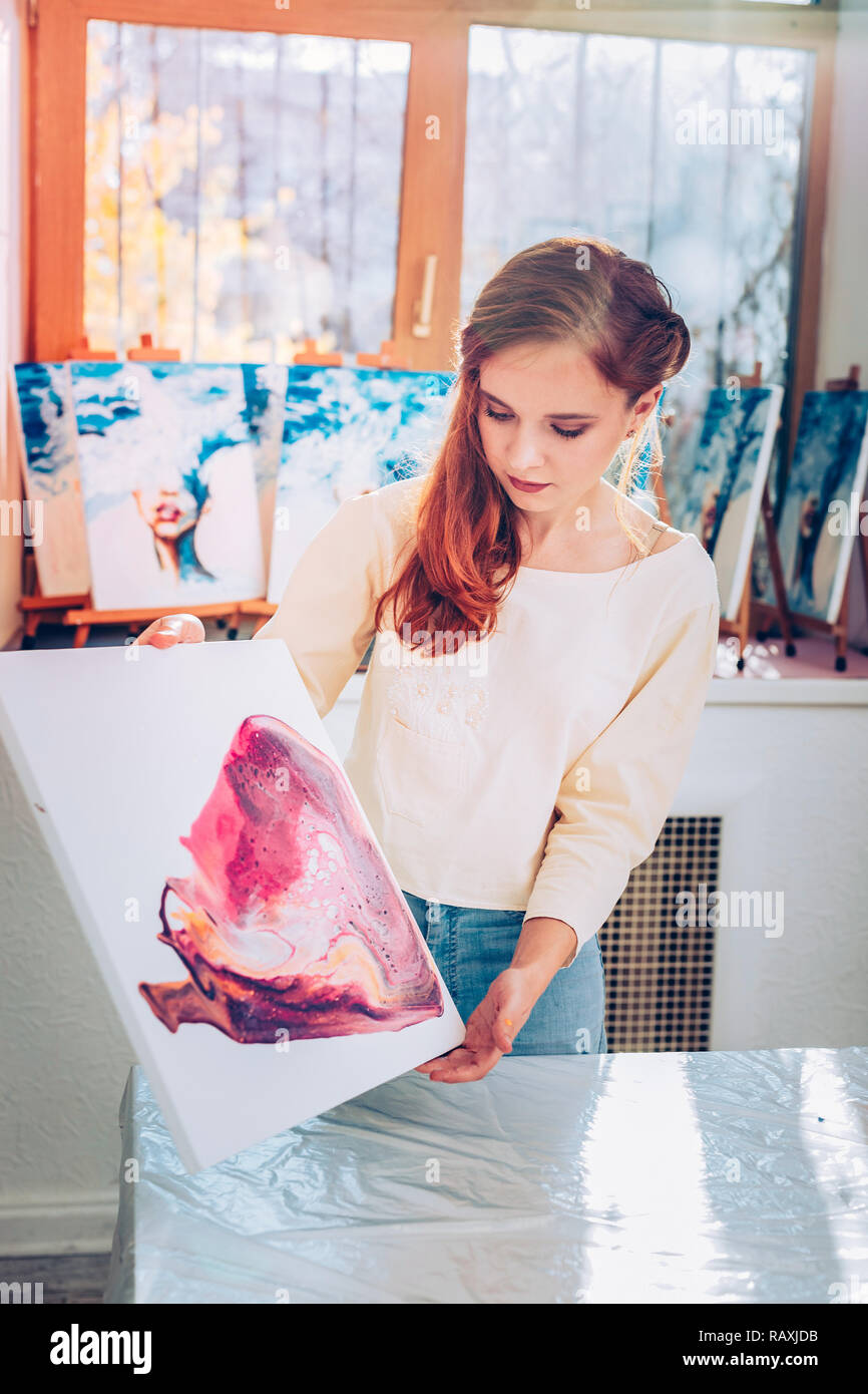 Top view of appealing inspired artist working in painting studio Stock ...