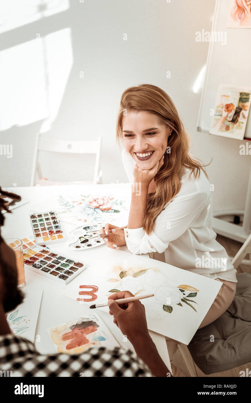 Cheerful beautiful stylish artist looking at her boyfriend Stock Photo ...