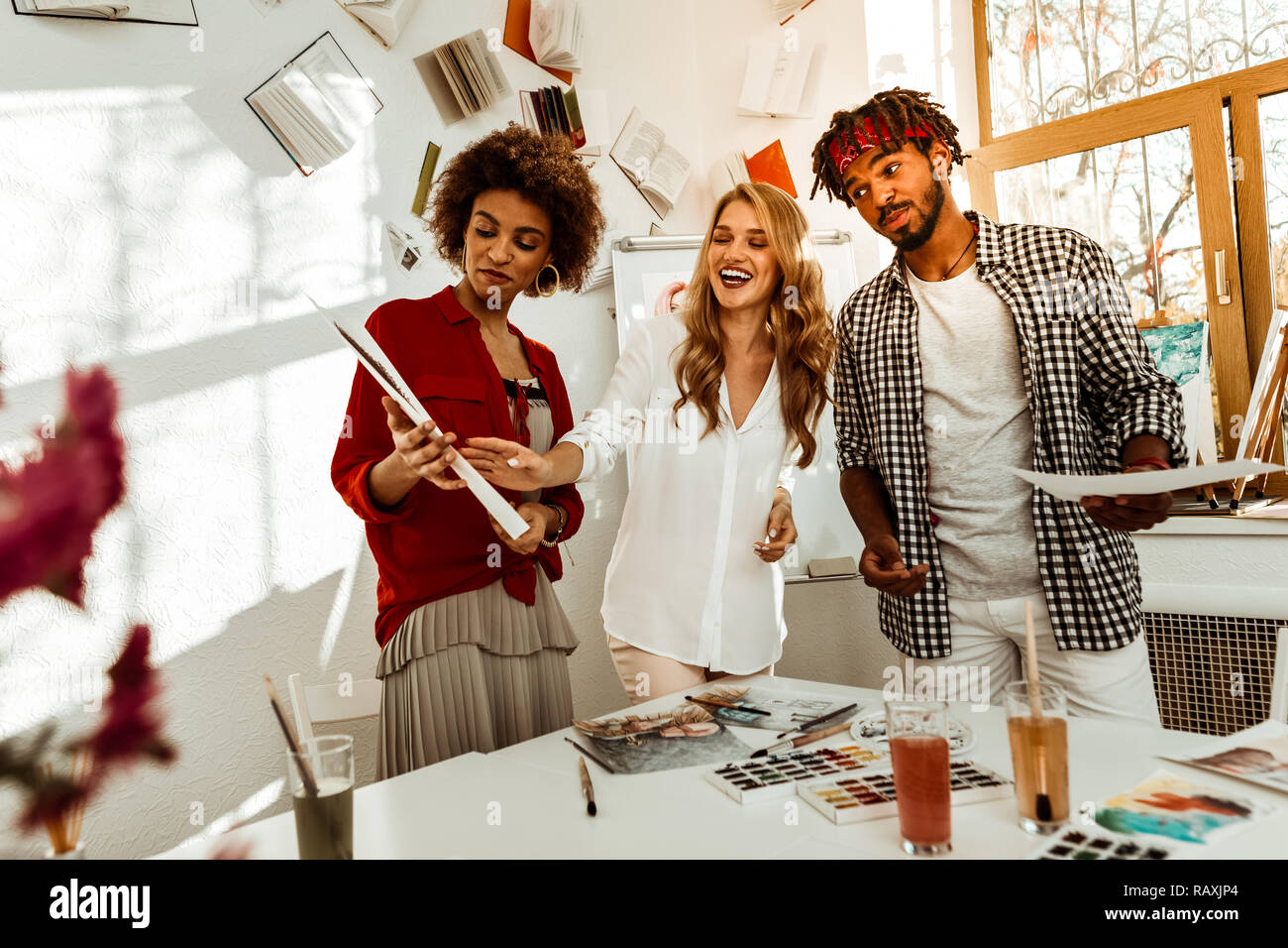Young artists gathering together showing their works to each other ...
