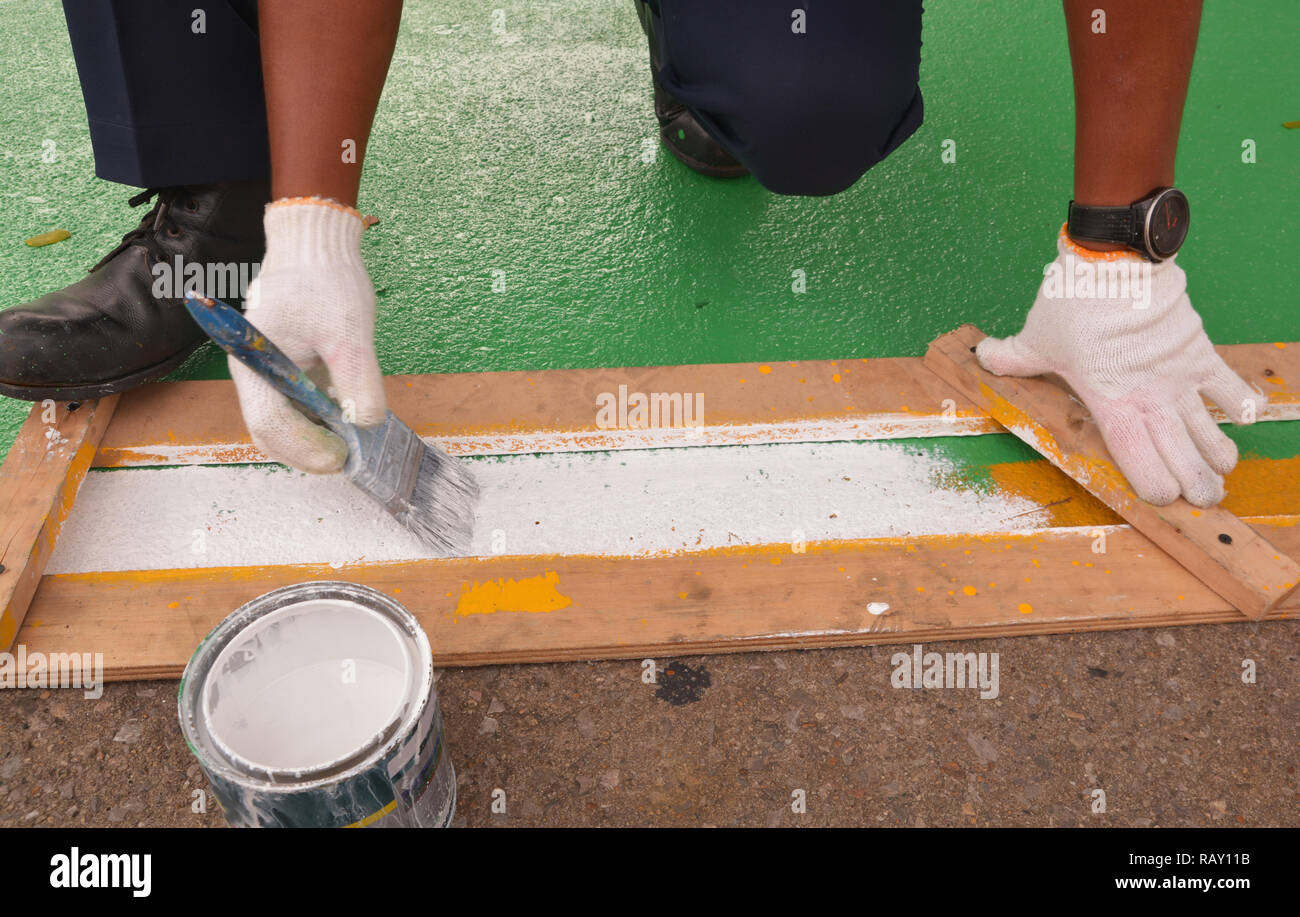 Road painter man worker marking street lines zebra crossing traffic ...