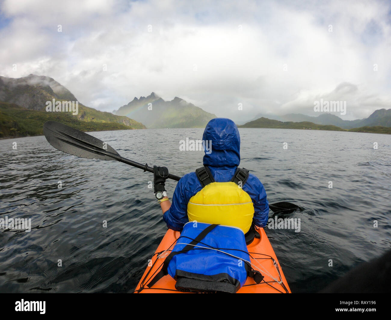 Photo from back of tourist with paddle on canoe floating Stock Photo ...