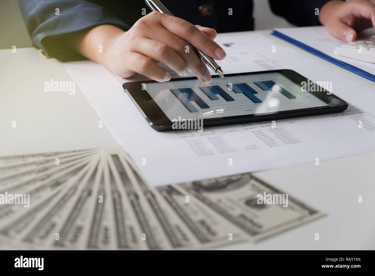 Women working in office. financial analysis with charts on pad for ...