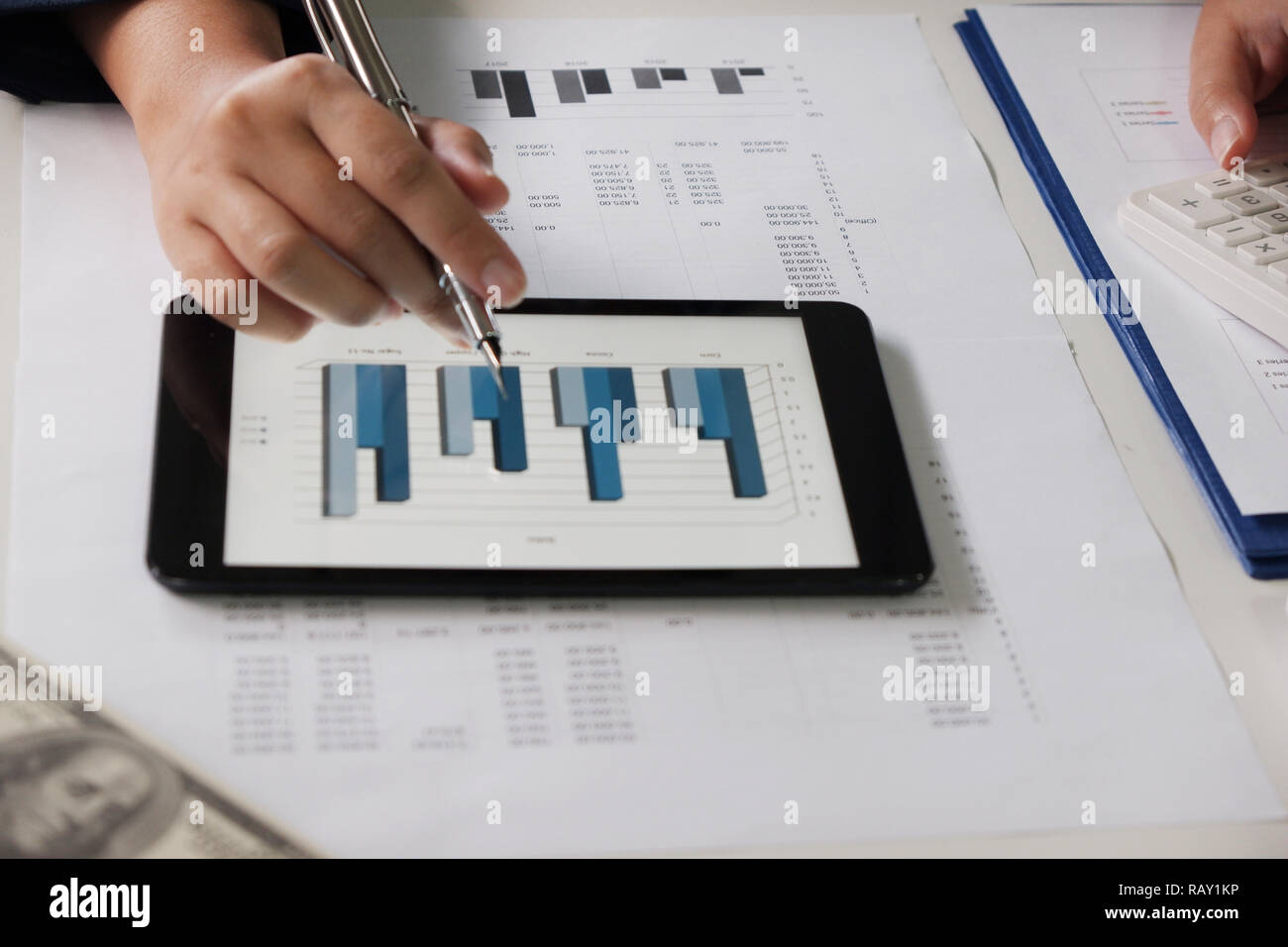 Women working in office. financial analysis with charts on pad for ...