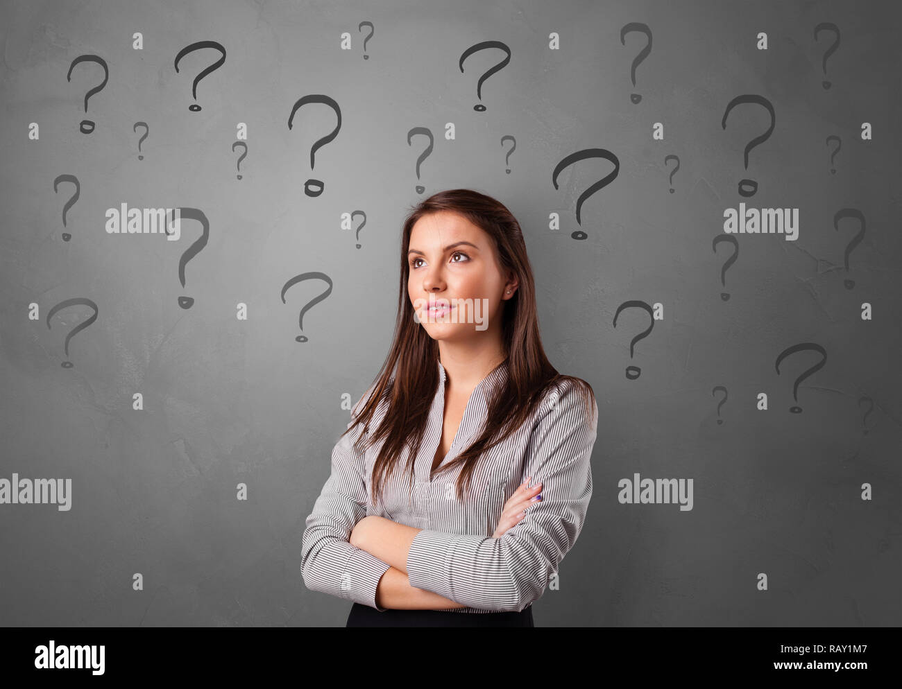 Person with question marks around face Stock Photo - Alamy