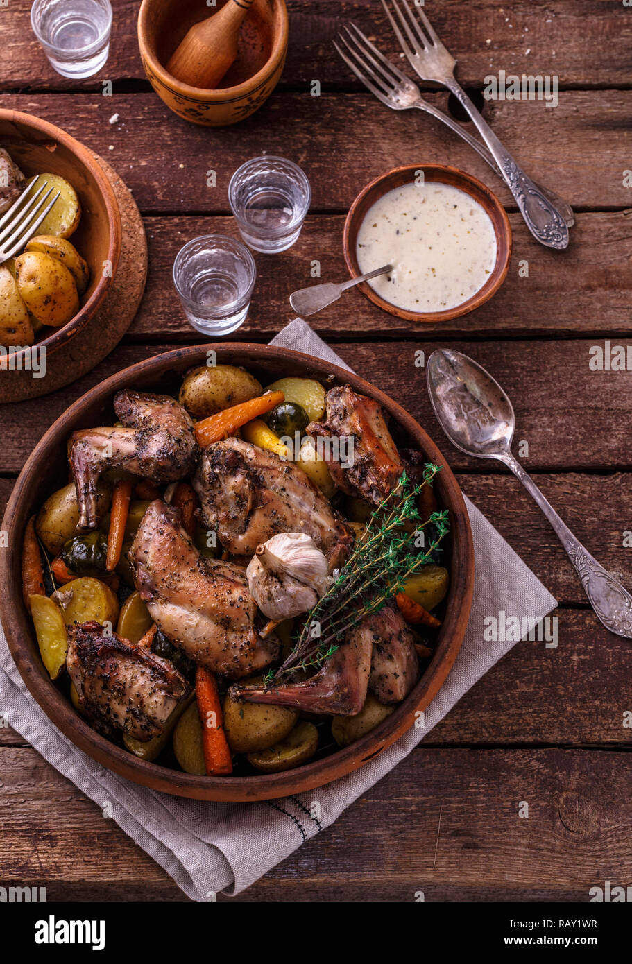 Oven baked rabbit with garlic sauce, copy space Stock Photo - Alamy
