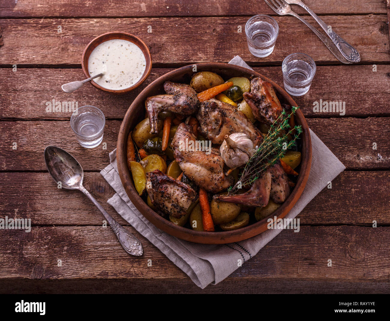 Oven baked rabbit with root vegetables and herbs, rustic style Stock ...
