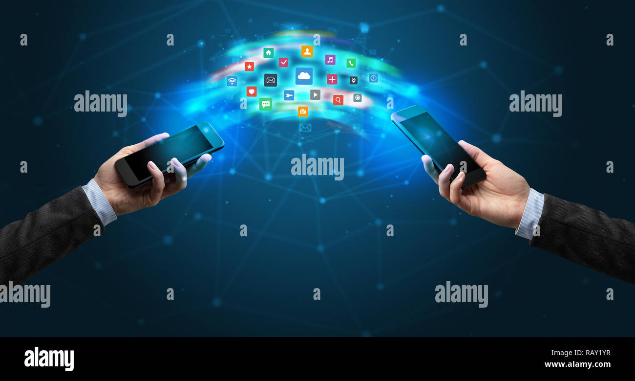 Two mobile phones syncing applications concept Stock Photo - Alamy