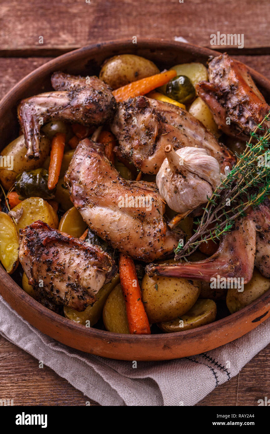 Oven baked rabbit with potato and carrots, top view Stock Photo - Alamy