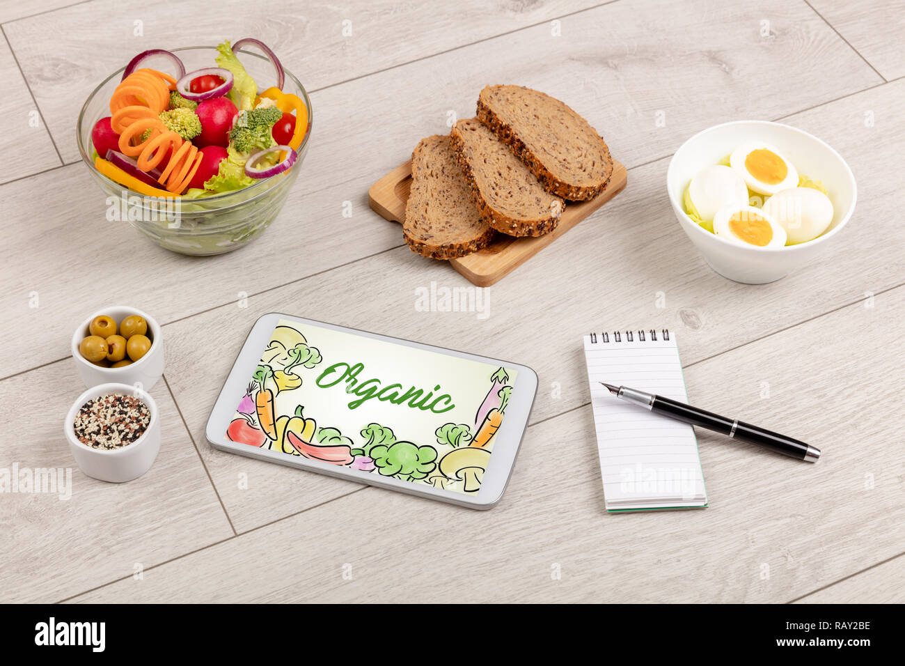 Healthy food composition with tablet Stock Photo - Alamy