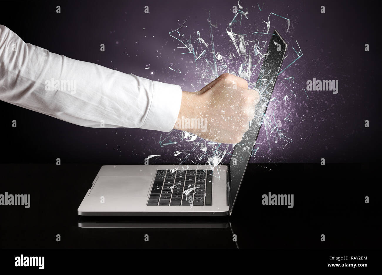 Hand hitting strongly laptop screen glass Stock Photo - Alamy