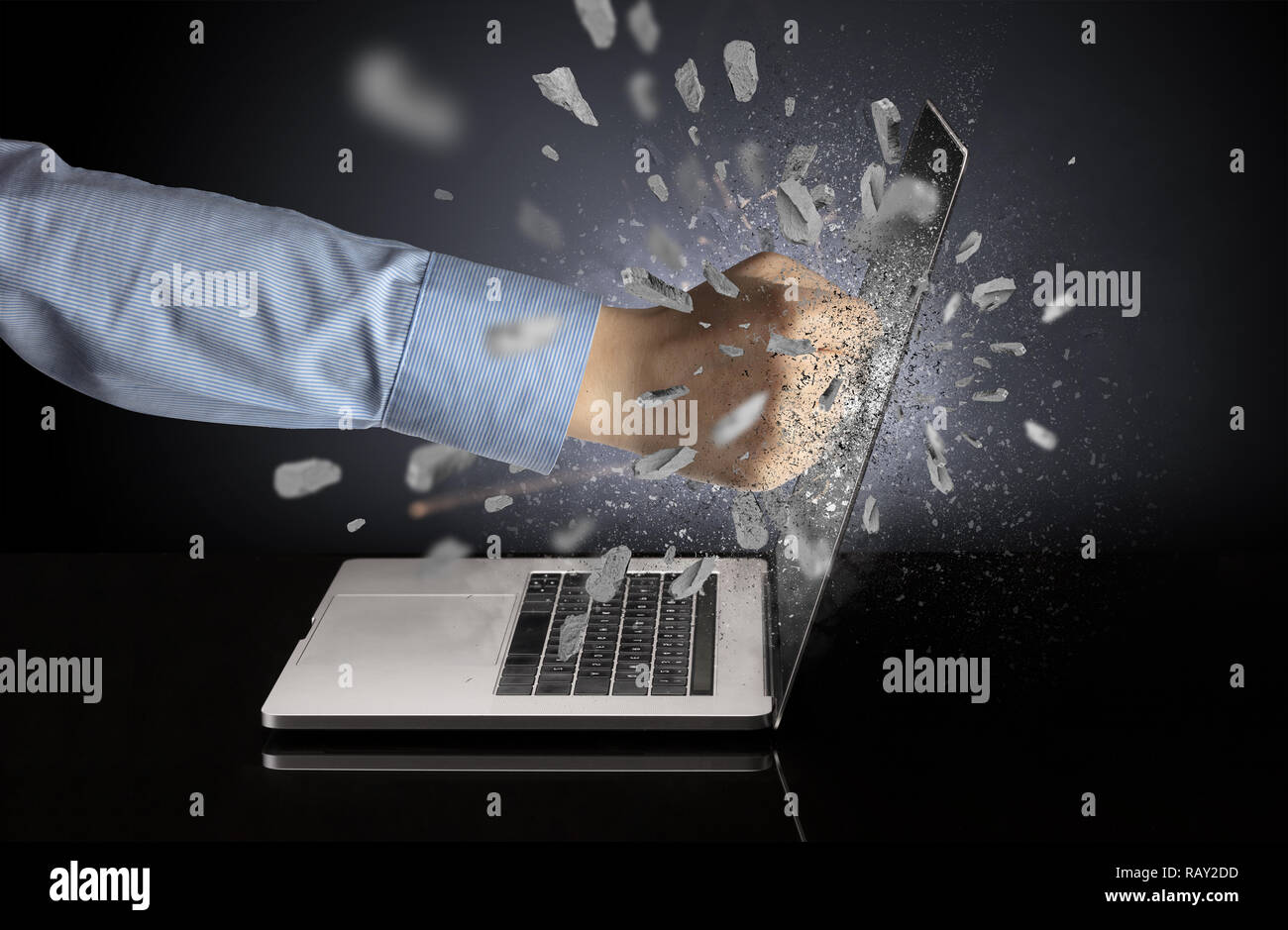 Strong male hand breaks laptop screen Stock Photo - Alamy