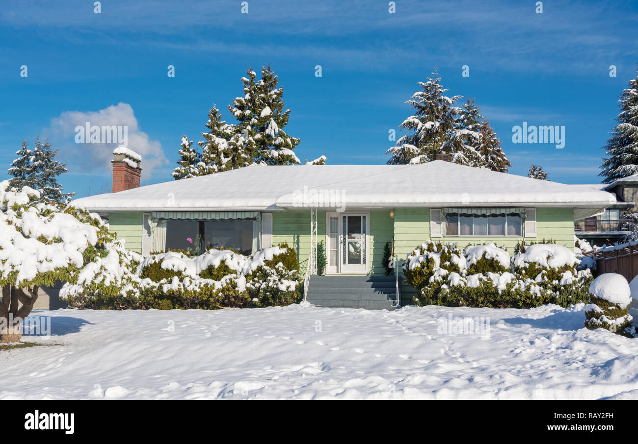 Family residential house with front yard in snow. North American house ...