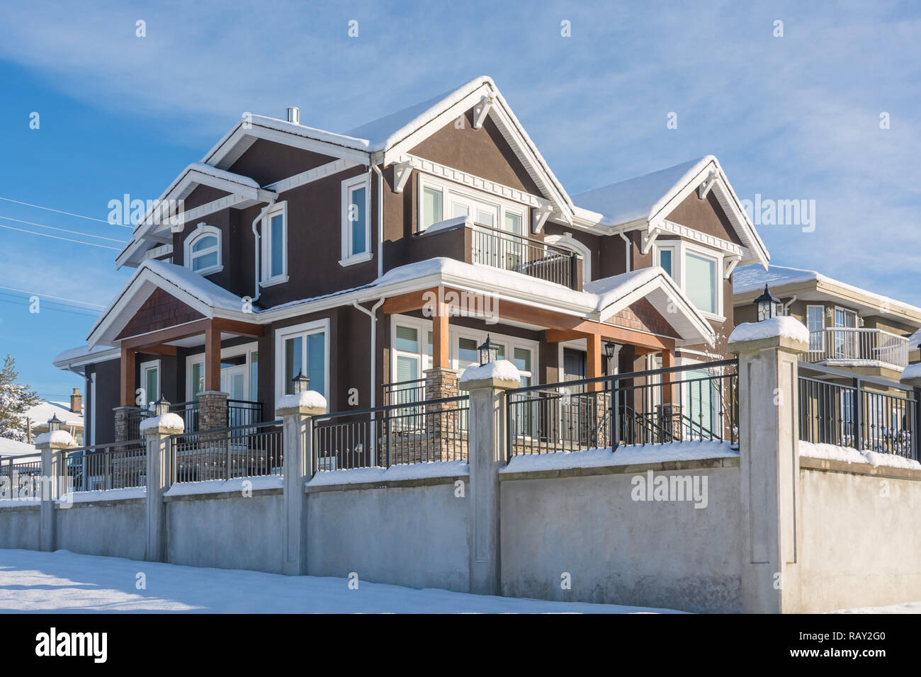 Luxurious residential house with front yard in snow. North American ...