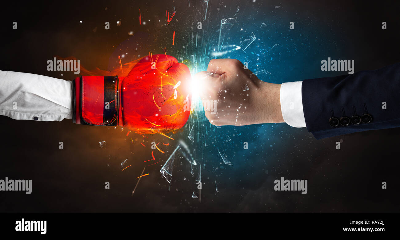 Two hands fighting and breaking glass into small pieces with fire and ...