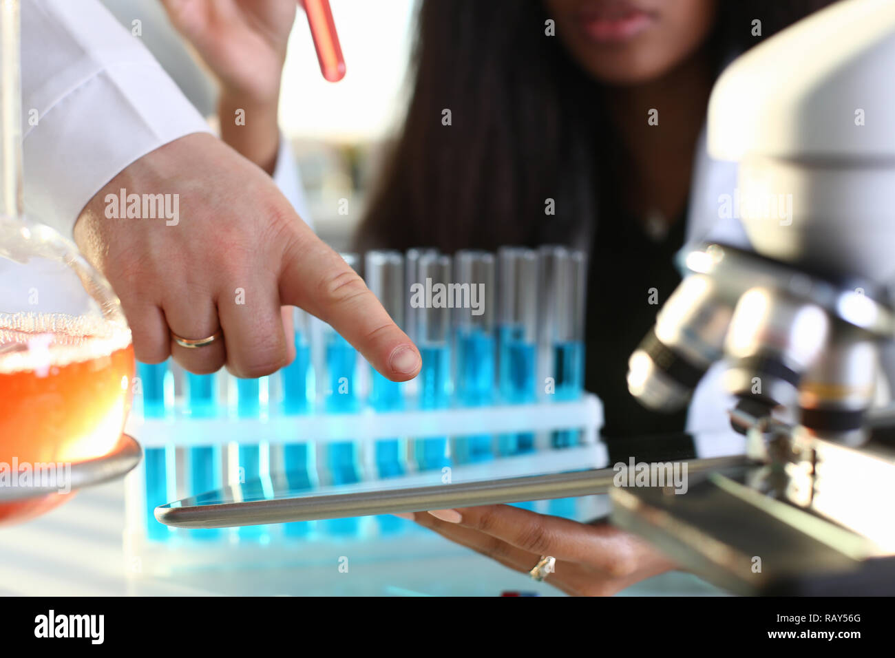 A female doctor in a chemical laboratory holds Stock Photo - Alamy