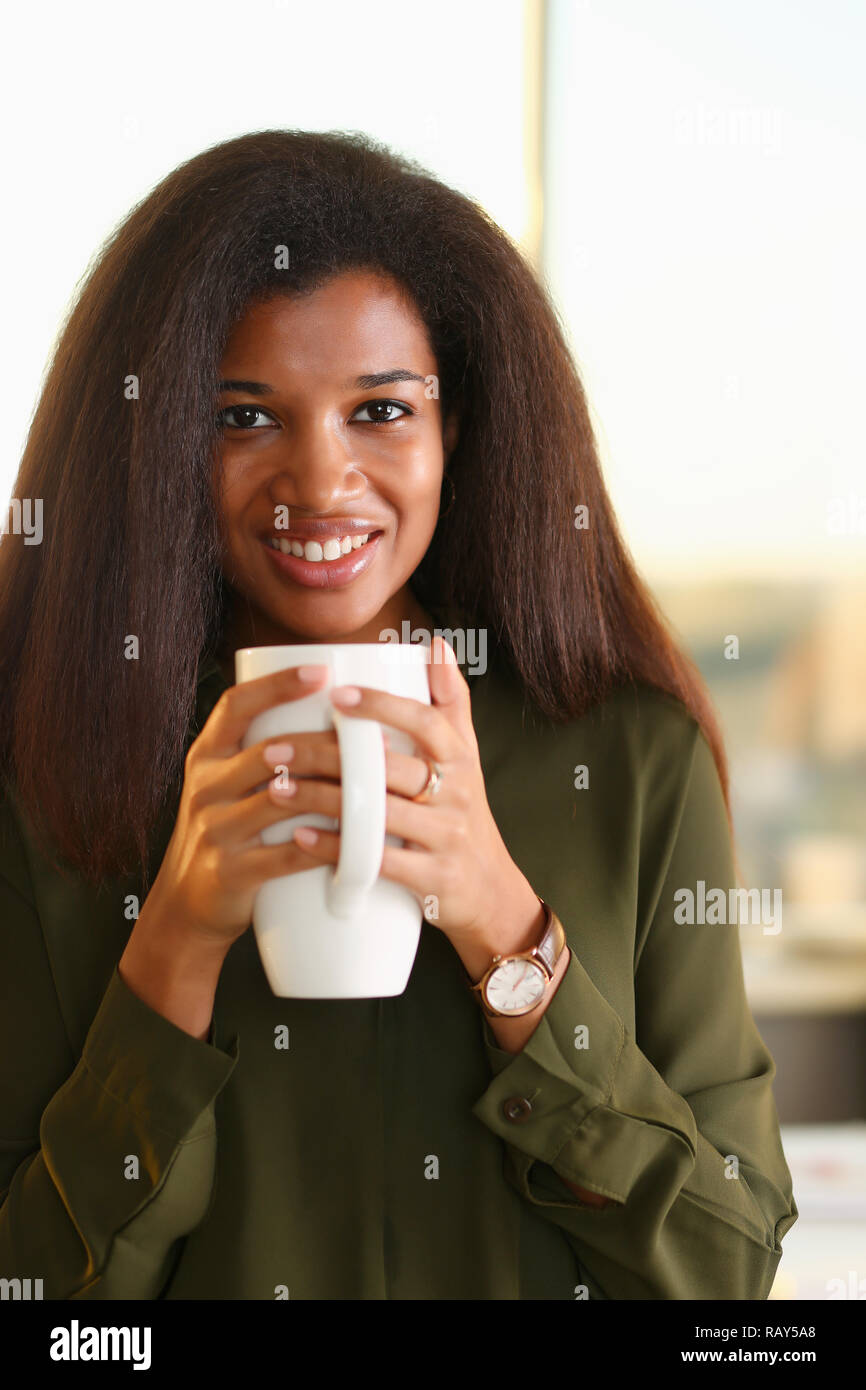 A black woman student in an office holds Stock Photo - Alamy