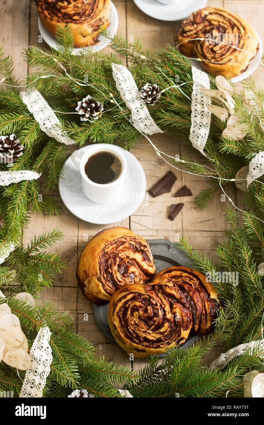 Snail chocolate muffins served with coffee on the background of a ...