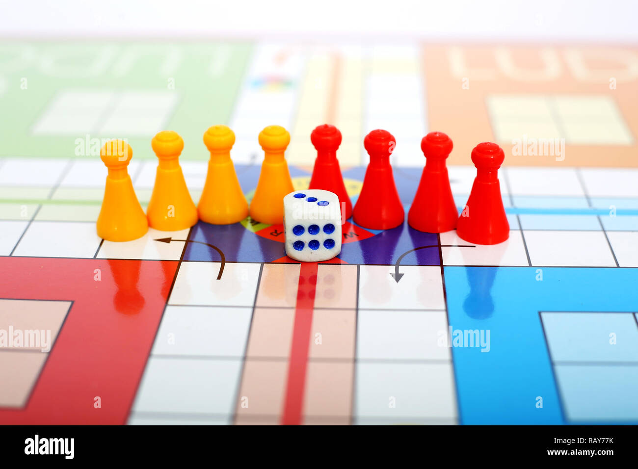 Picture of red and yellow pawns with dice on the ludo game Stock Photo ...