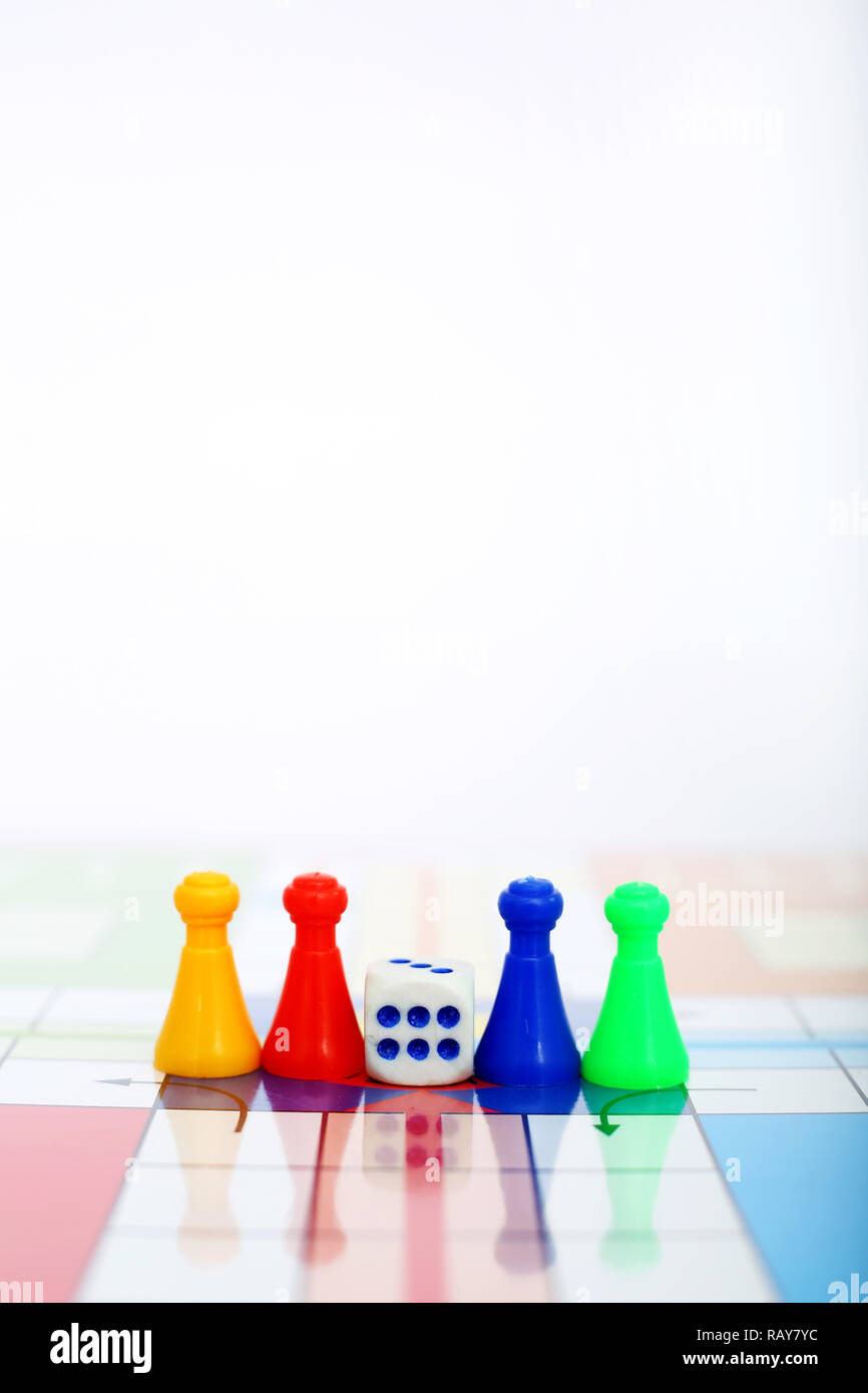 Picture of different color pawns with dice Stock Photo - Alamy