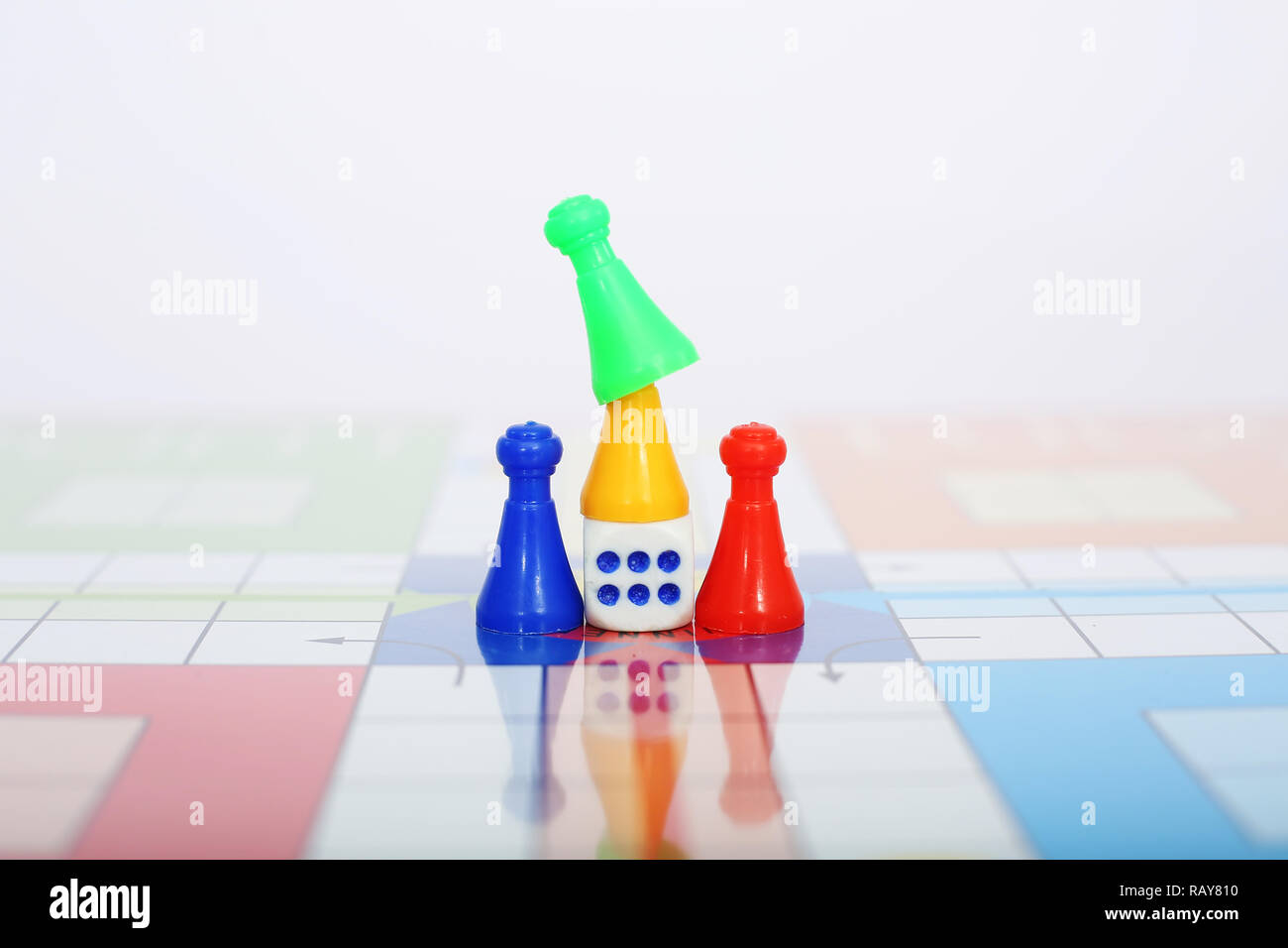 Portrait of different color pawns with dice Stock Photo - Alamy