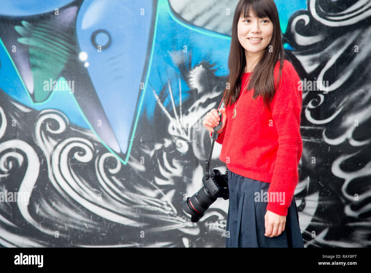 Asian female model poses for pictures on the street Stock Photo - Alamy