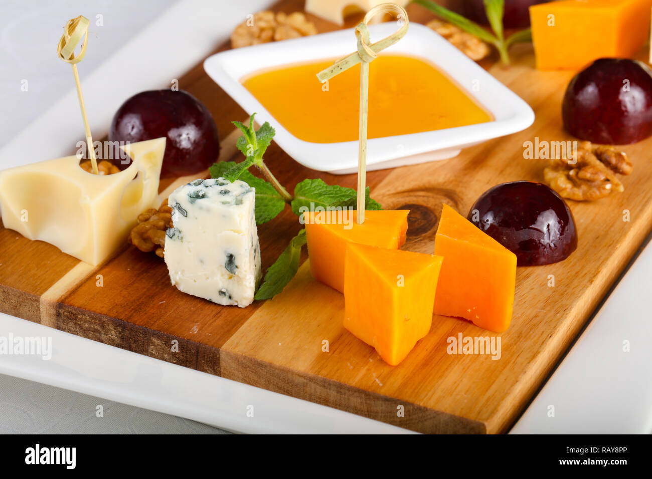 Cheese plate mix with grape, honey and nuts Stock Photo - Alamy