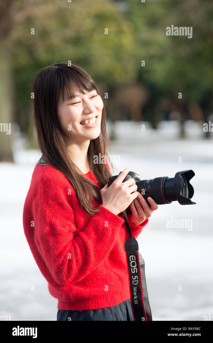 Asian female model poses for pictures on the street Stock Photo - Alamy