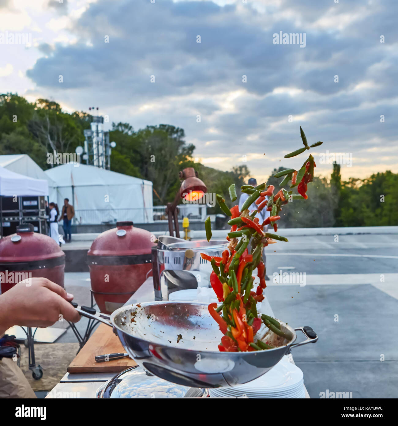 chef tossing vegetables in a wok in an outdoor kitchen Stock Photo - Alamy