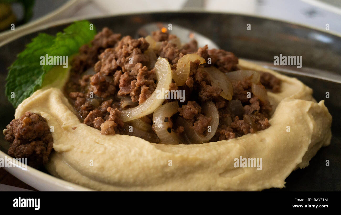 Plate of typical Lebanese hummus seasoned in various ways Stock Photo ...