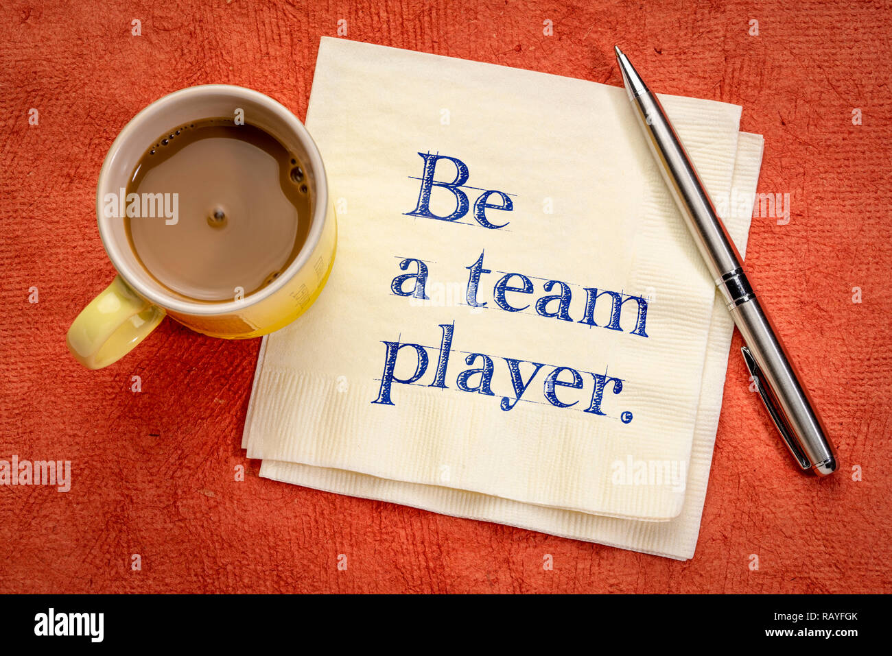 Be a team player advice - handwriting on a napkin with a cup of coffee ...