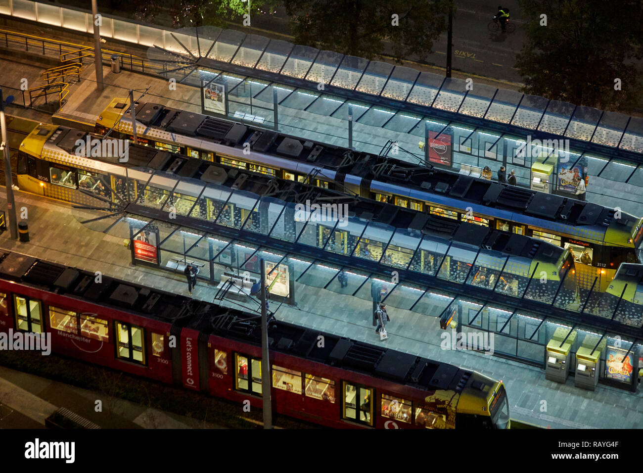 Manchester at night a busy Castlefield metrolink tram station stop ...