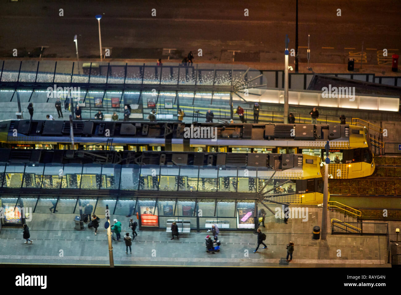 Manchester at night a busy Castlefield metrolink tram station stop ...