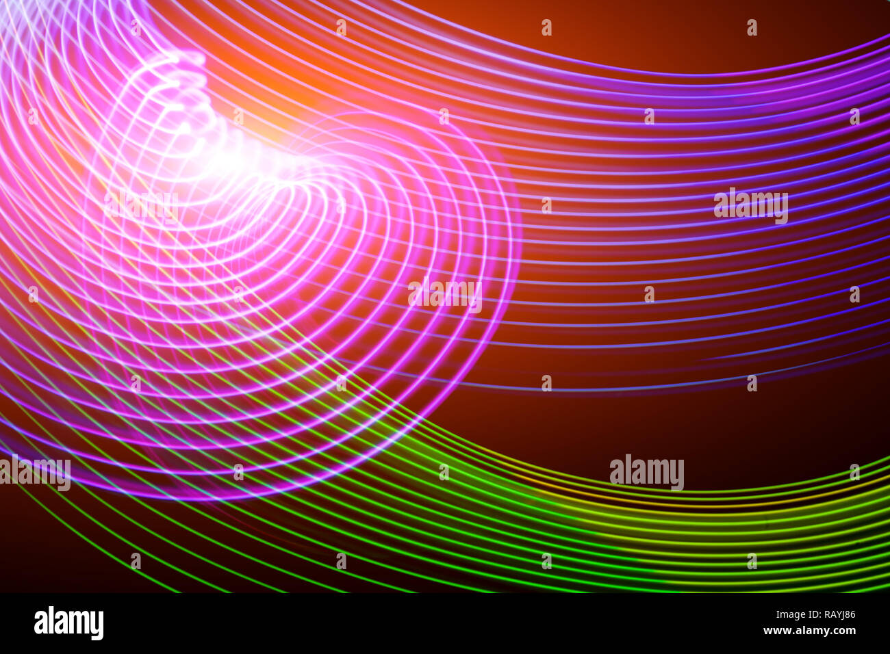 Abstract yellow, pink, blue and green neon glowing crossing lines ...