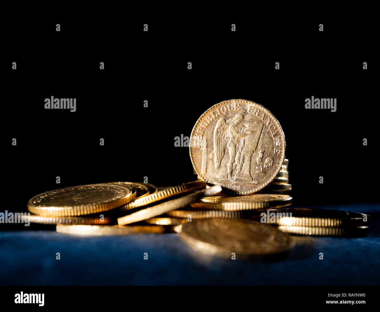 Real Gold coins over dark background Stock Photo - Alamy