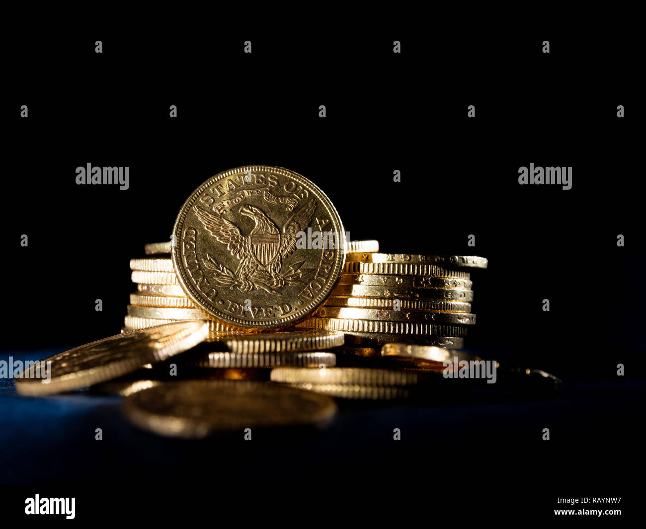 Real Gold coins over dark background Stock Photo - Alamy