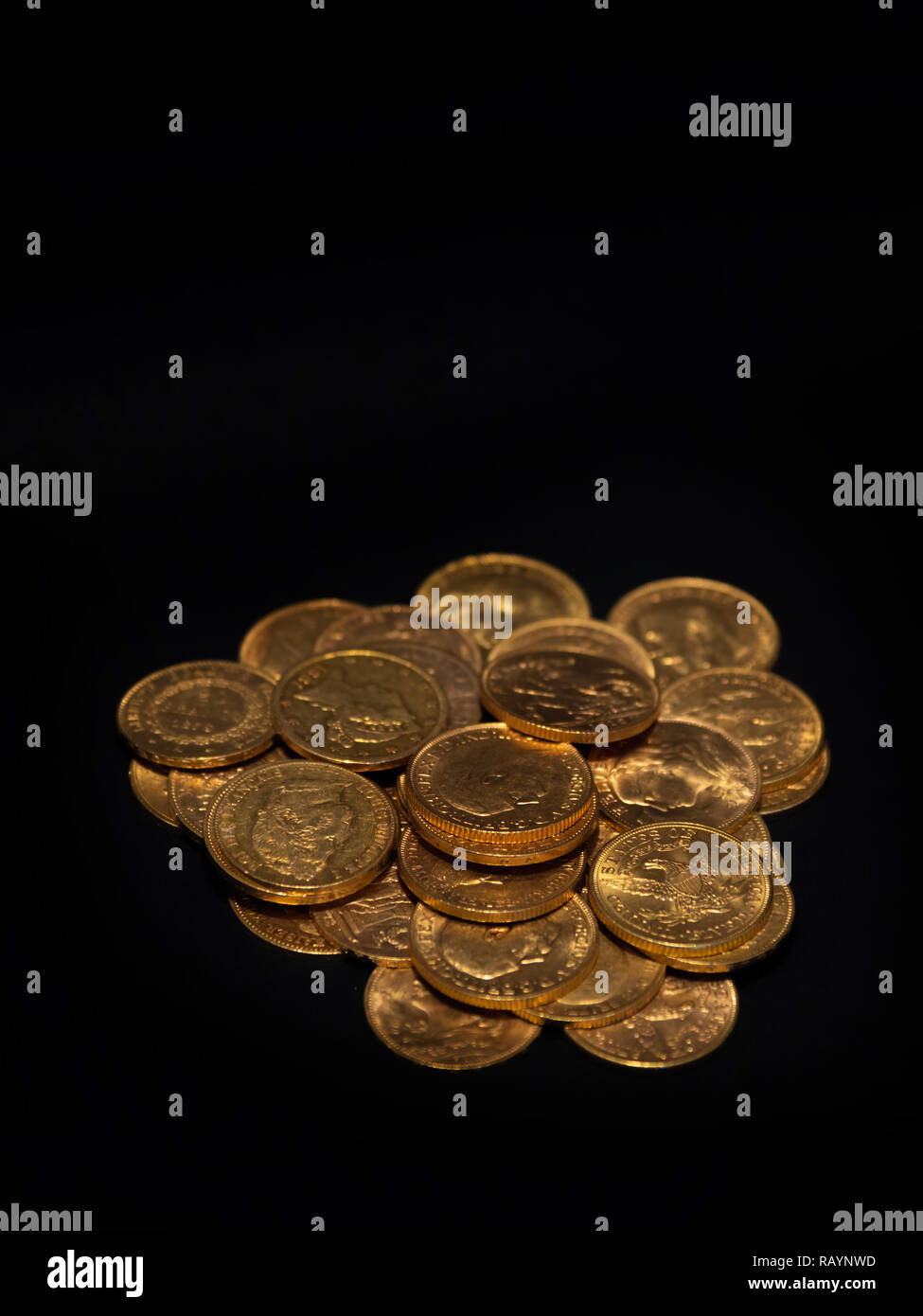 Real Gold coins over dark background Stock Photo - Alamy