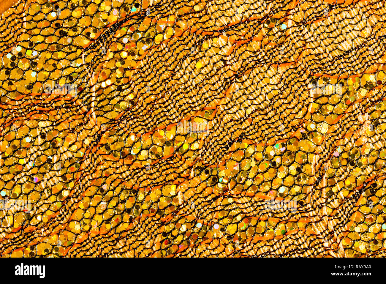 Abstract background of gold sequins on lace Stock Photo - Alamy